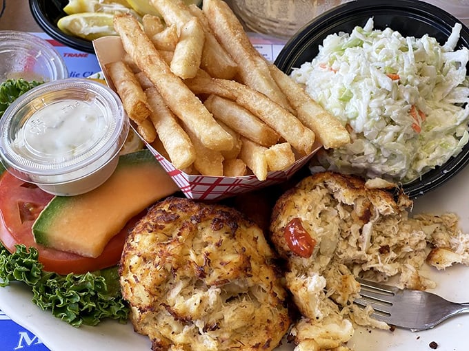 Lump crab cakes that are practically all crab &ndash; paired with crispy fries and fresh slaw, it's the seafood trifecta of happiness.