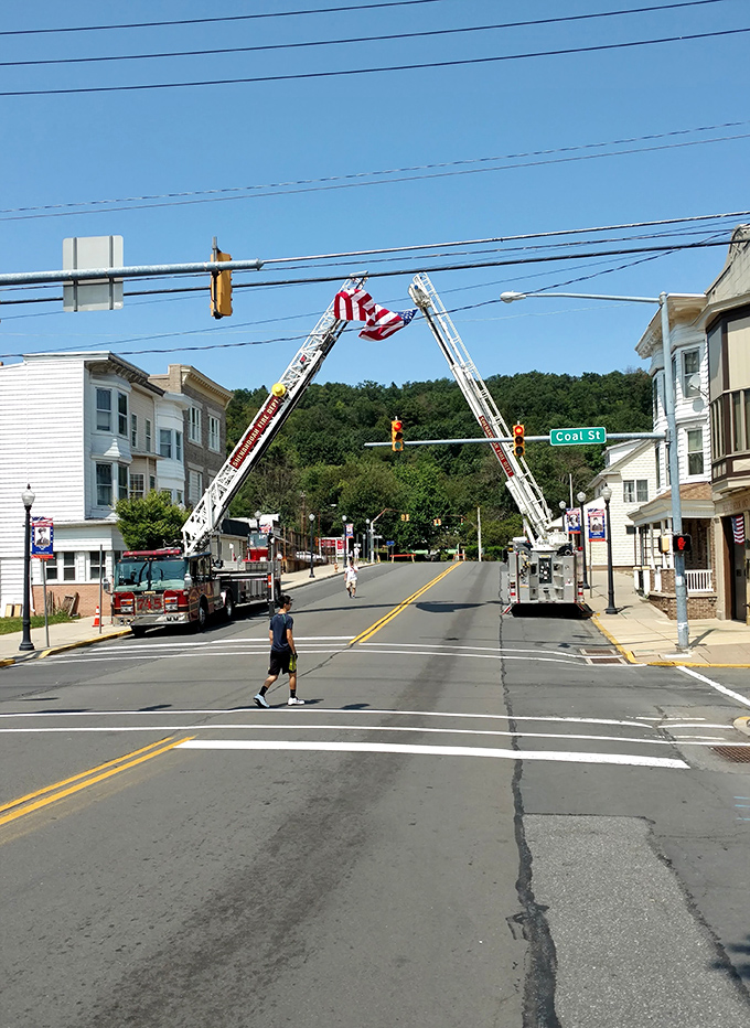 Nothing says "small-town America" like fire trucks creating a stars-and-stripes gateway. Coal Street's name itself whispers the town's industrial legacy. 