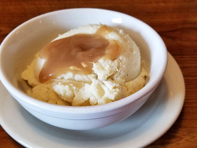 Mashed potatoes so perfectly cloud-like, they make you wonder if the chef moonlights as a pillow designer.