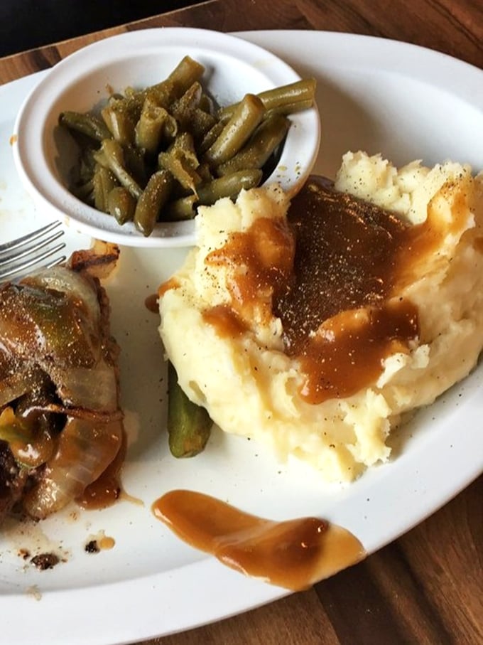 These mashed potatoes and green beans aren't just sides&mdash;they're supporting actors that deserve their own Oscar. The gravy river makes everything better.