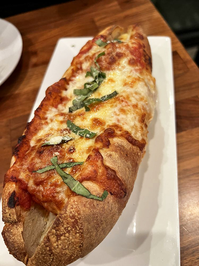 This isn't just a sandwich; it's a carefully constructed meatball delivery system with melted cheese and fresh basil that would make any nonna nod approvingly.