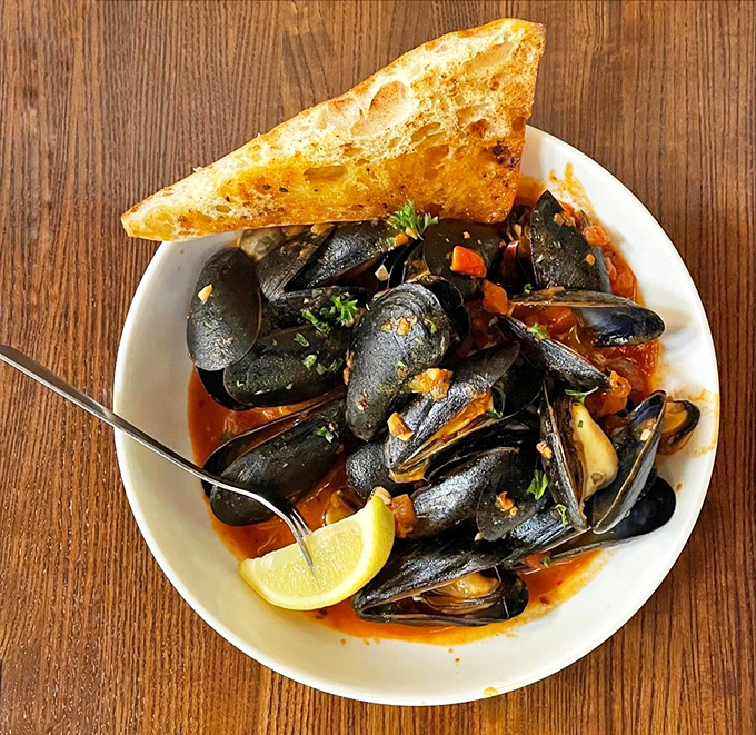 These mussels aren't just swimming in sauce&mdash;they're vacationing in a flavor spa, complete with crusty bread for sopping up every last drop.