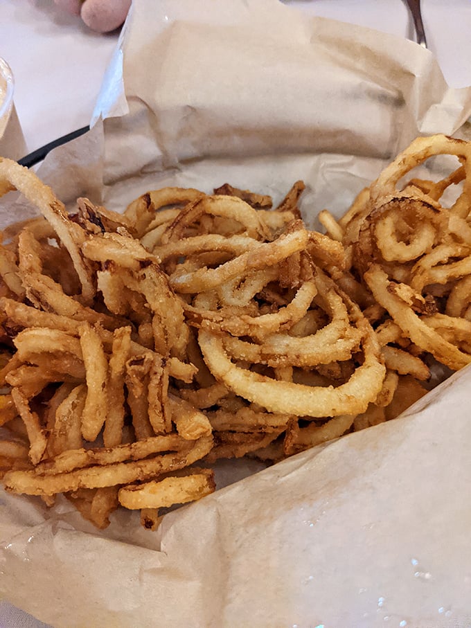 Onion rings so perfectly crisp and abundant they spill from their basket like a treasure chest of golden deliciousness. Diet plans, beware.