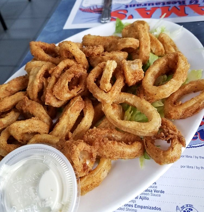 Crispy calamari rings stacked like delicious golden halos. These aren't your average onion rings &ndash; they're ocean-flavored circles of joy.