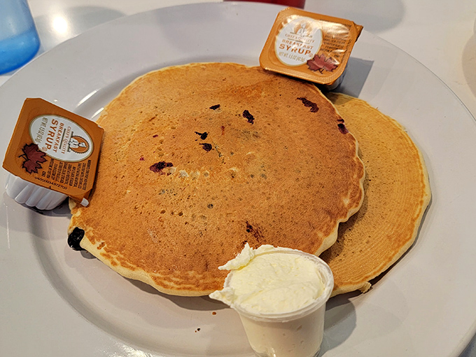 These pancakes aren't just breakfast, they're edible sunshine—golden-brown discs waiting for that maple syrup waterfall moment.