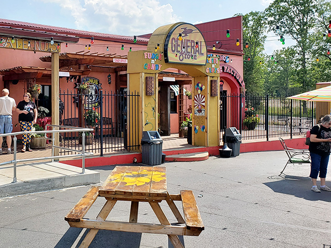 Rustic picnic tables outside the General Store offer a moment of respite for weary travelers, with colorful storefronts providing that perfect Route 66 ambiance.