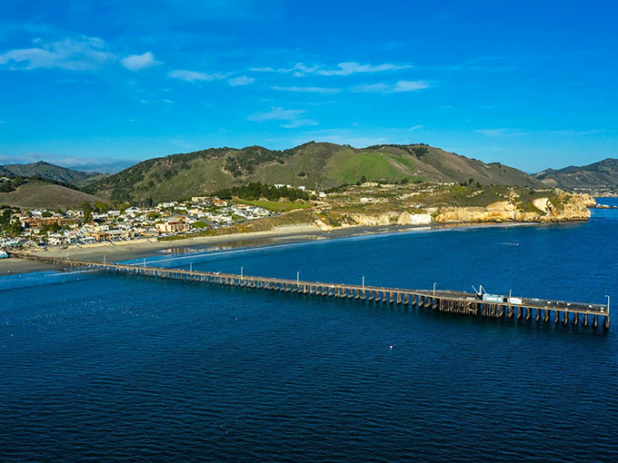 The pier stretches toward the horizon like a runway for dreams, connecting land-lovers to the ocean's endless possibilities.