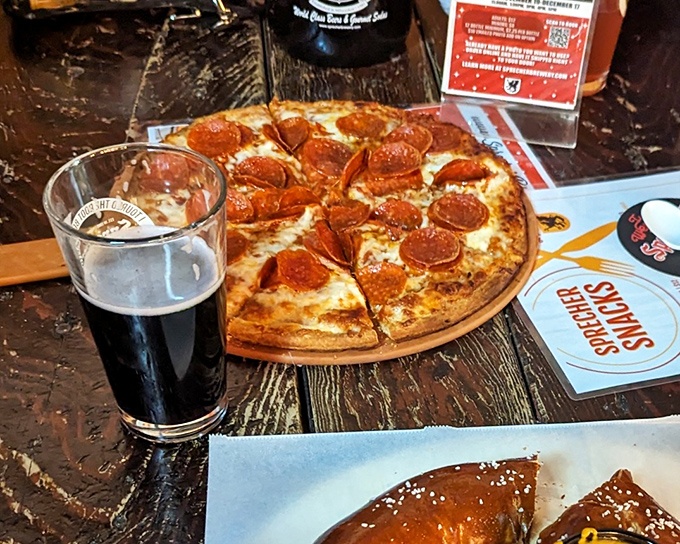 Pizza and dark beer &ndash; a pairing so perfect it should have its own holiday. The pepperoni curls up at the edges like it's waving hello.