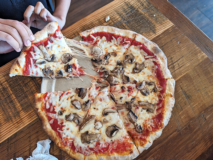 This mushroom pizza isn't trying to impress food critics; it's trying to make you forget every other pizza you've ever had. Mission accomplished.