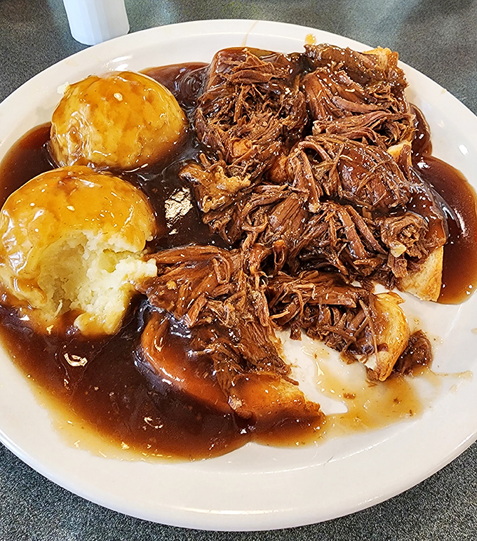 Pot roast that falls apart at the mere suggestion of a fork, swimming in gravy rich enough to make a banker jealous. Those rolls are begging to mop it up. 