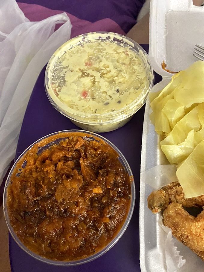 Soul food heaven in a styrofoam container—creamy potato salad and candied yams that taste like someone's been stirring them with love all day.