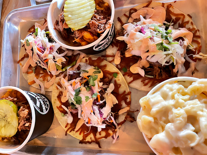 Pulled pork tacos topped with fresh slaw and served with creamy mac and cheese&mdash;proof that fusion food can respect both traditions.