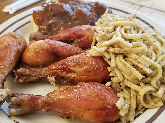 Golden-brown chicken alongside buttered noodles&mdash;a plate that whispers "you're home now" even if you grew up a thousand miles from Amish country.