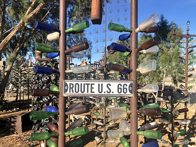 Route 66 memorabilia mingles perfectly with bottle art, celebrating America's most famous highway in colorful glass harmony.
