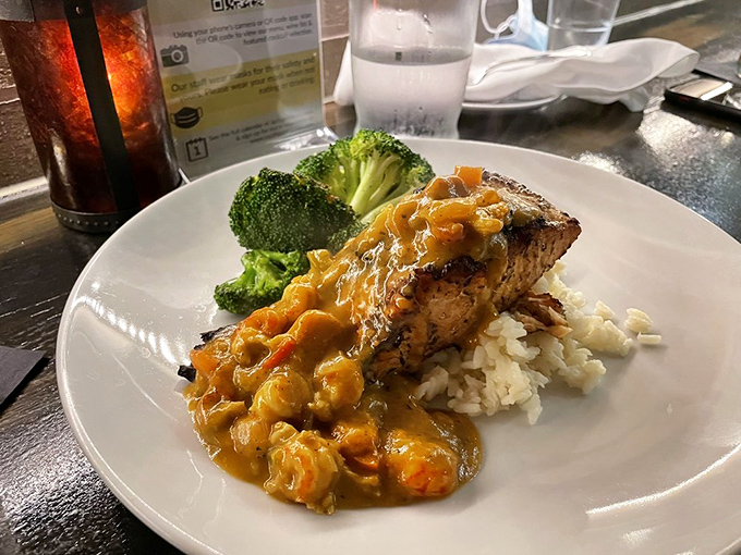 This salmon perched atop rice, draped in sauce, with broccoli standing by&mdash;it's the aquatic visitor who dressed up for the Southern soir&eacute;e.
