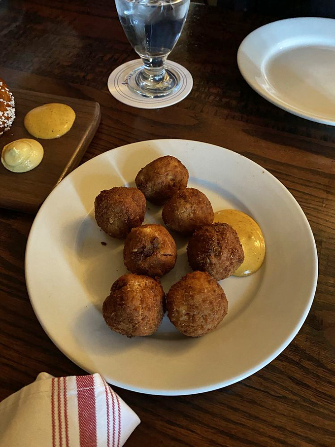 The legendary sauerkraut balls in their natural habitat&mdash;golden-brown spheres of joy served with house-made mustard that'll haunt your dreams.