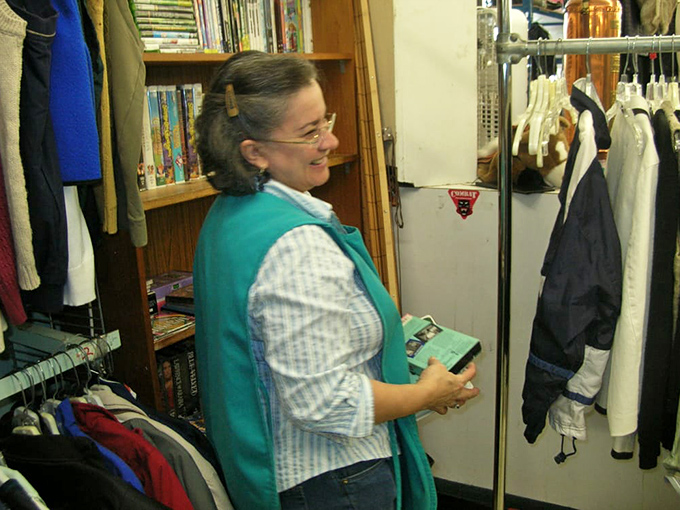 Between the books and clothing racks, staff members guide treasure hunters through the labyrinth of possibilities with practiced expertise.