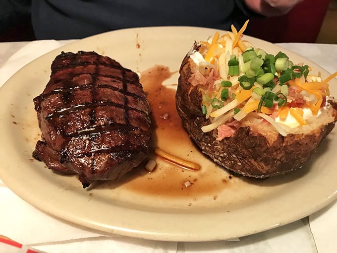 A steak with grill marks so perfect they could be patented, alongside a loaded baked potato that's dressed better than most people at the mall.