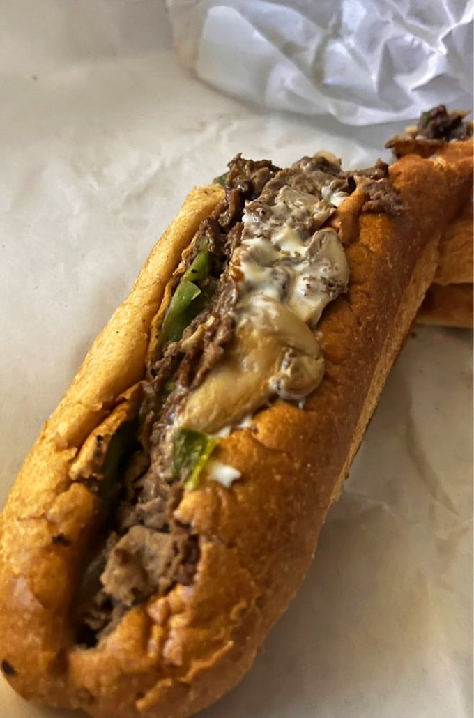 When cheese meets steak meets perfectly toasted roll. The melty goodness visible at the edges is nature's way of saying "eat me now."
