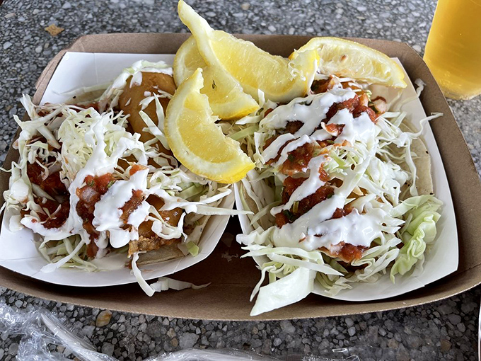 Fish tacos done right &ndash; crispy, flaky fish nestled under fresh cabbage with a drizzle of sauce that ties everything together in tortilla harmony.