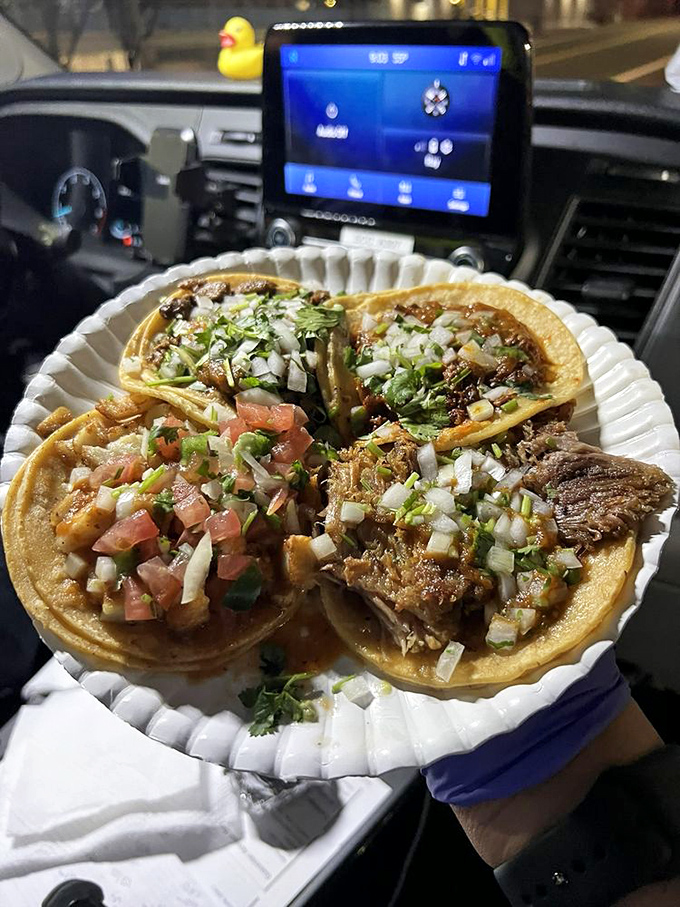 A taco trinity that would make any food pilgrim weep with joy. The car dashboard dining room just adds to the authentic experience.