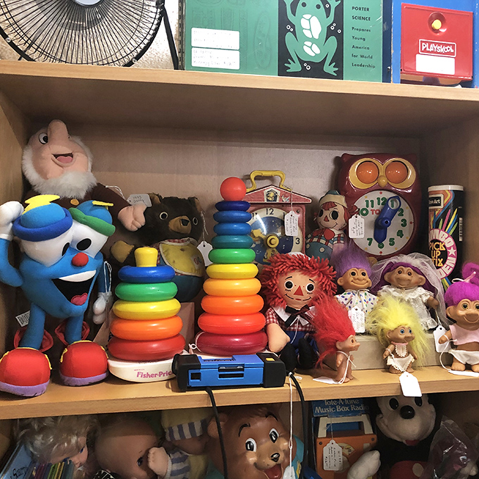 A shelf of childhood memories awaits adoption. That Fisher-Price stacking ring probably taught motor skills to kids who now have grandchildren of their own.
