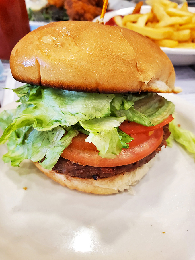 This isn't just a burger—it's architectural perfection. The ratio of bun to patty to fresh toppings creates the structural integrity engineers dream about.