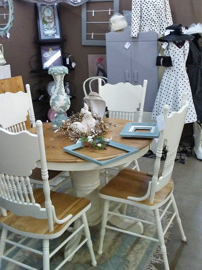 This farmhouse dining set with white-painted chairs could star in any home renovation show—shabby chic before it became a Pinterest category.
