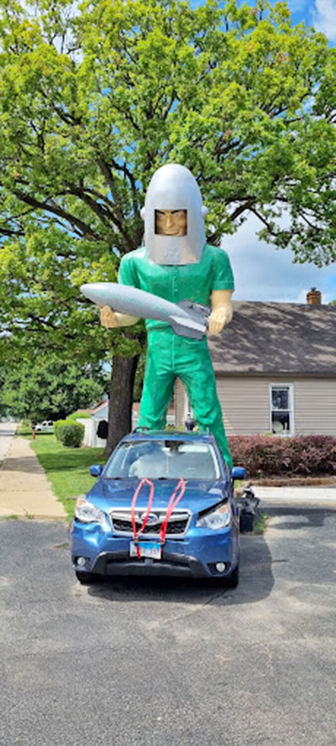 When your car photobombs a giant, you know you've found the perfect roadside attraction for the whole family.