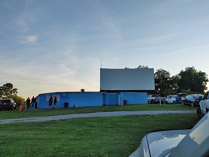 Twilight at Brownsville Drive-In&mdash;where the screen stands ready and the evening's entertainment awaits just beyond your windshield.