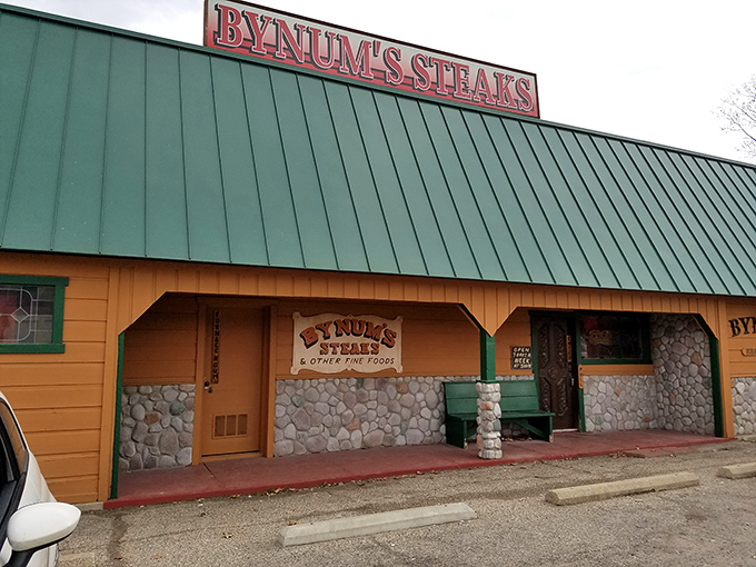 Bynum's distinctive green roof and stone accents stand out like a beacon for hungry travelers seeking steak nirvana.