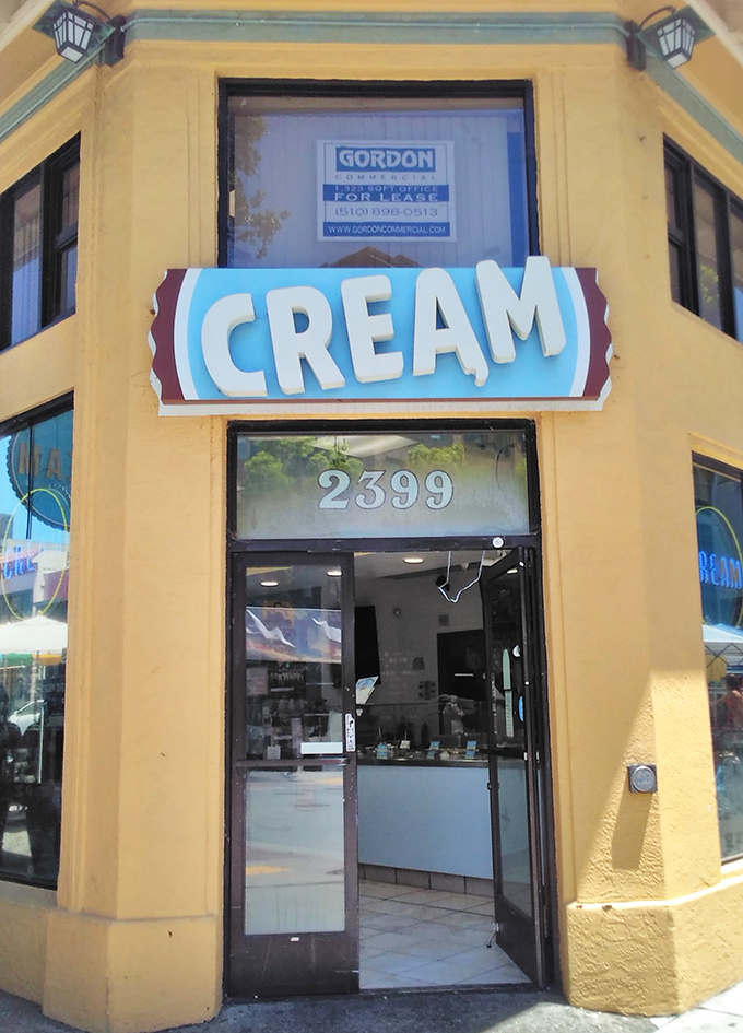 CREAM's sunny corner spot promises happiness in cookie form. The simple yellow building hides revolutionary dessert combinations.
