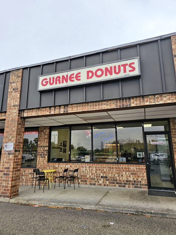 Gurnee Donuts' classic brick facade and bold red sign scream "neighborhood institution." Those yellow tables have heard countless morning conversations!