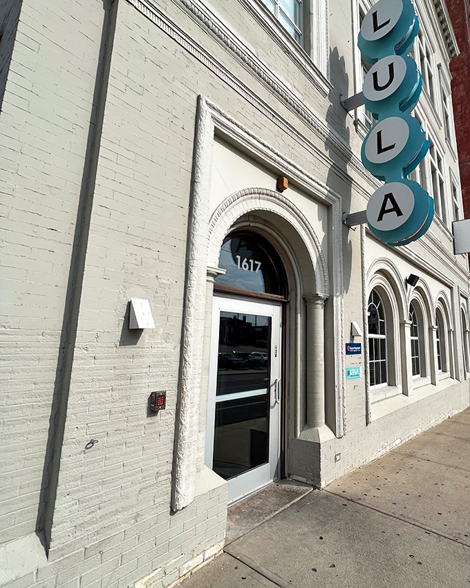 Lula's elegant white exterior and blue signage hint at the sophisticated Southern experience waiting inside.