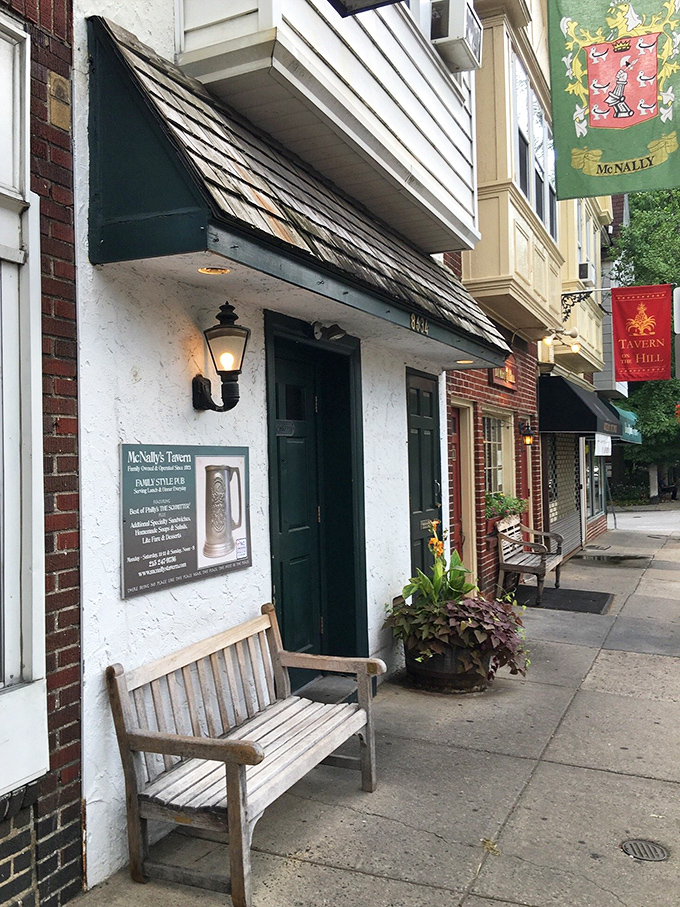 McNally's charming exterior with its wooden bench feels like stepping into Philadelphia's storied past—sandwich history awaits inside.