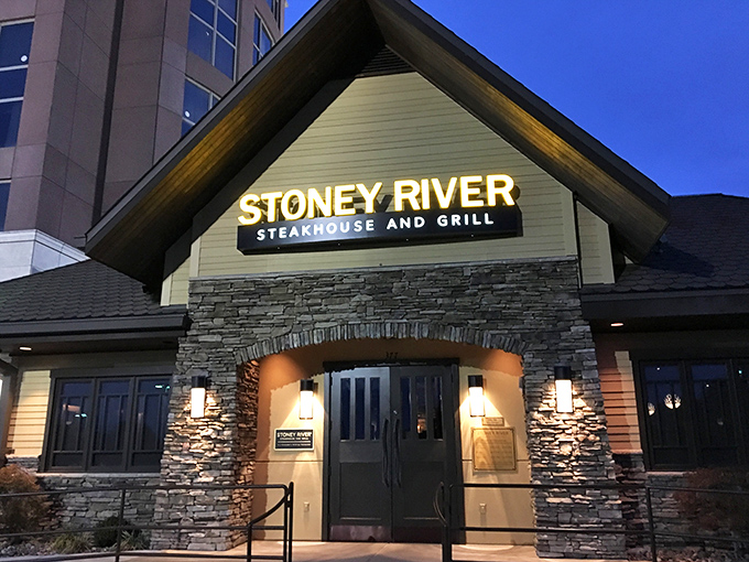 Stoney River's glowing entrance promises mountain lodge comfort with suburban convenience. The steaks deliver on that warm welcome.