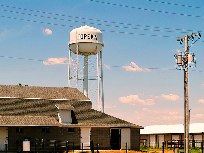 Topeka's water tower stands sentinel over farmland where traditional ways of life continue to thrive against modern backdrops.