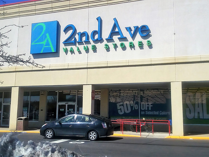 Morning light catches 2nd Ave's distinctive blue and green logo. The "50% OFF" sign in the window is music to any bargain hunter's ears.