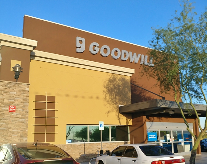 Desert landscaping frames this sleek Goodwill location, where bargain hunters flock for treasures under the Arizona sun.