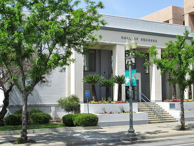 The Bakersfield Hall of Records showcases the city's architectural heritage amid lush greenery. History and affordability in perfect harmony.
