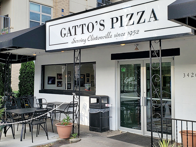 The simple outdoor seating suggests this place has confidence that their pizza will keep you coming back.