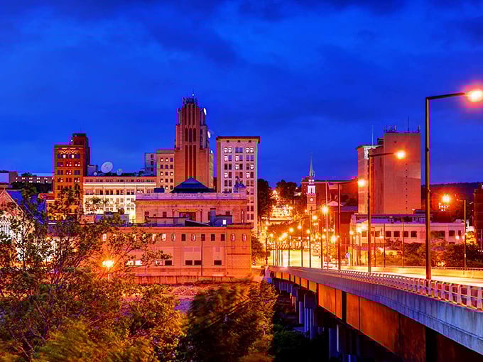 Youngstown&rsquo;s skyline glows at twilight, historic buildings rising as an illuminated bridge welcomes you into the city.