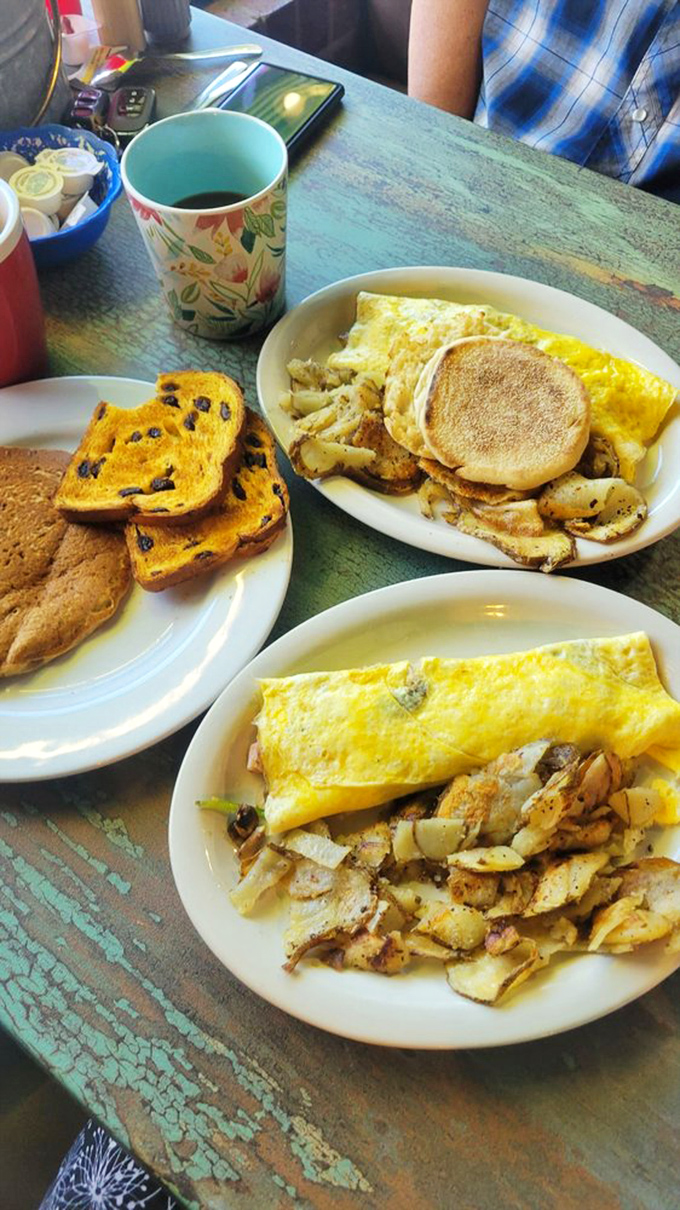 Sunshine-yellow omelets that practically glow with promise, flanked by home fries that have clearly been on speaking terms with butter and spices.