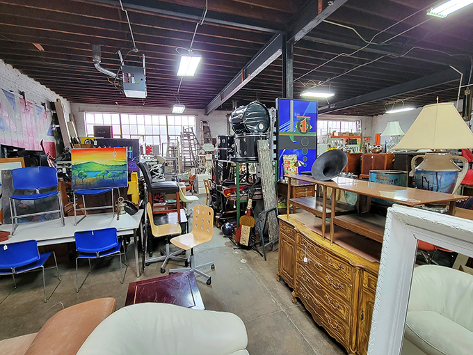 Office chairs mingle with artwork in this democratic display. The blue seats look ready for a meeting, while the paintings dream of gallery walls.