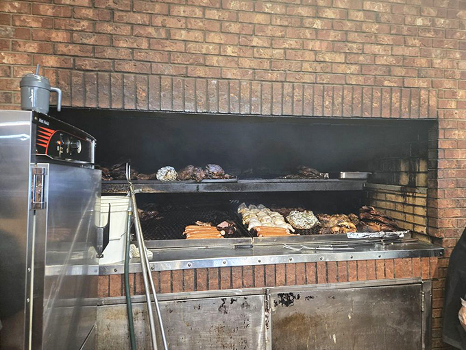 The brick pit where all the smoky magic happens, turning ordinary meat into extraordinary memories one patient hour.