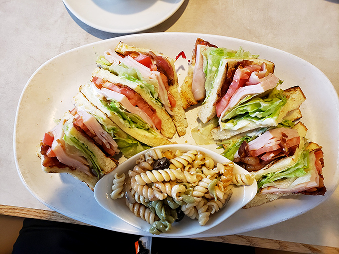 The club sandwich&mdash;architecture you can eat. Perfectly triangled, strategically stacked, and surrounded by pasta salad reinforcements.