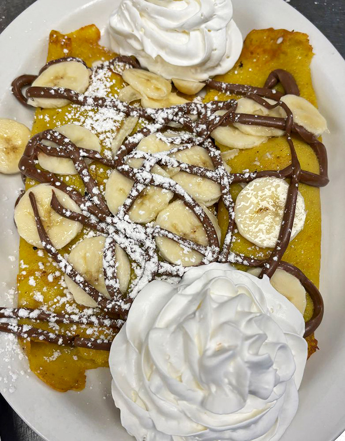 Banana and Nutella unite on golden crepes with generous dollops of whipped cream&mdash;a breakfast indulgence that makes Monday feel like Saturday.