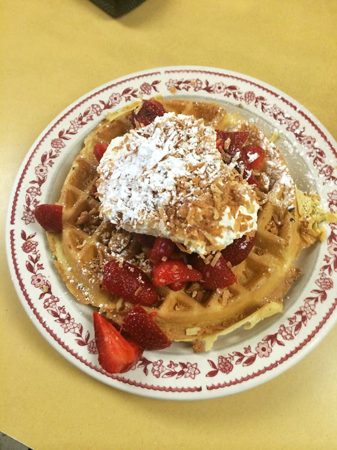 A Belgian waffle that's dressed for success with strawberries, whipped cream, and enough powdered sugar to make your dentist wince with delight.