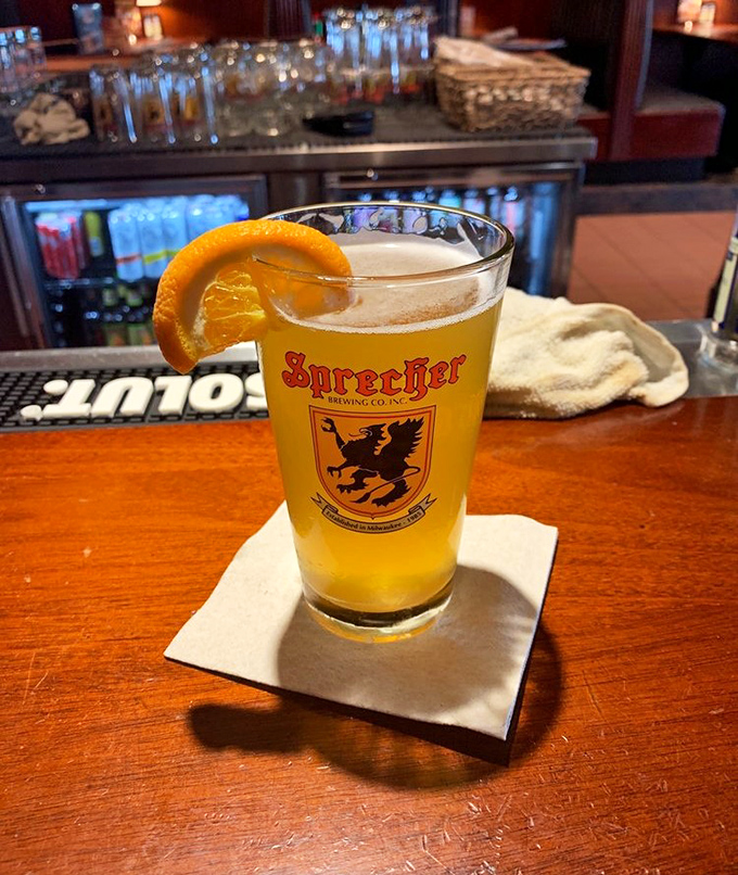 A perfectly poured Sprecher with an orange slice &ndash; because in Wisconsin, beer is both art form and necessary food group.