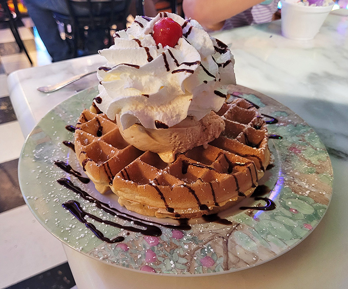 Waffles aren't just for breakfast anymore! This Belgian beauty supports a tower of ice cream and whipped cream like a delicious foundation of happiness.